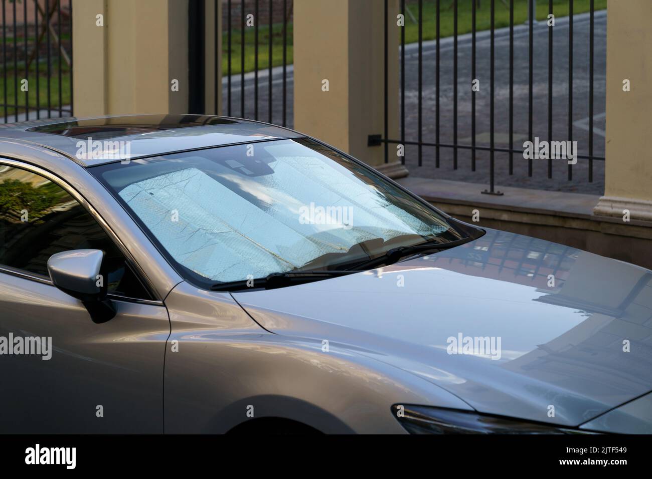 Protective reflective surface under windshield of car on hot day ...