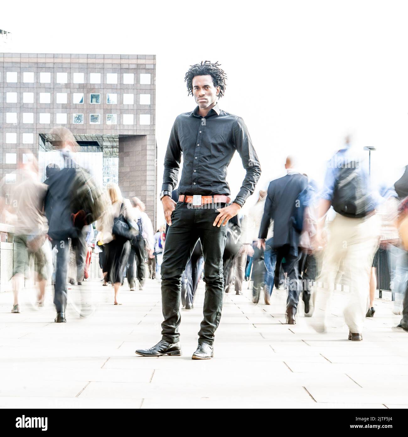 Against the Flow. An individual standing confidently against the flow ...