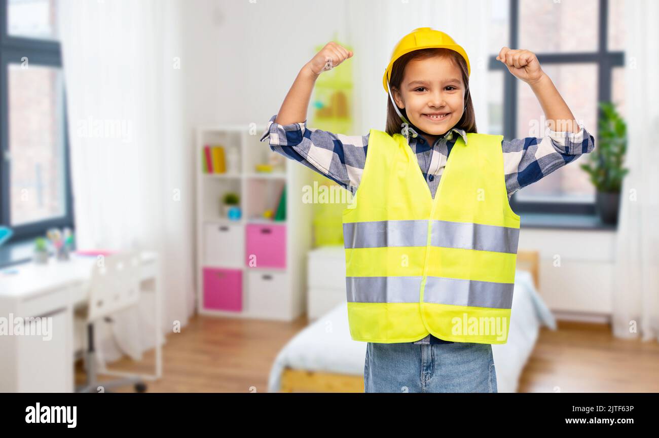 girl in helmet and safety vest showing power Stock Photo - Alamy