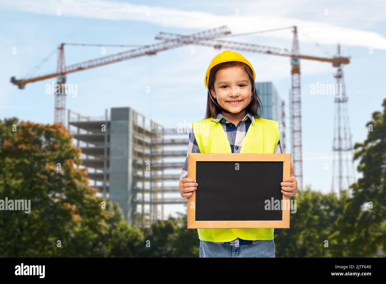 little girl in construction helmet with chalkboard Stock Photo - Alamy