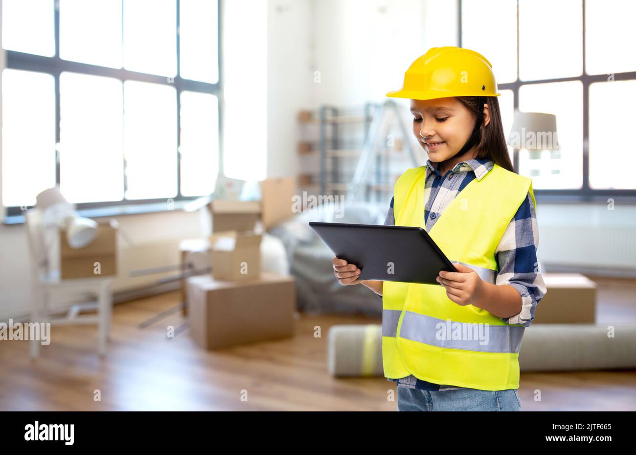 girl in helmet and safety vest with tablet pc Stock Photo - Alamy