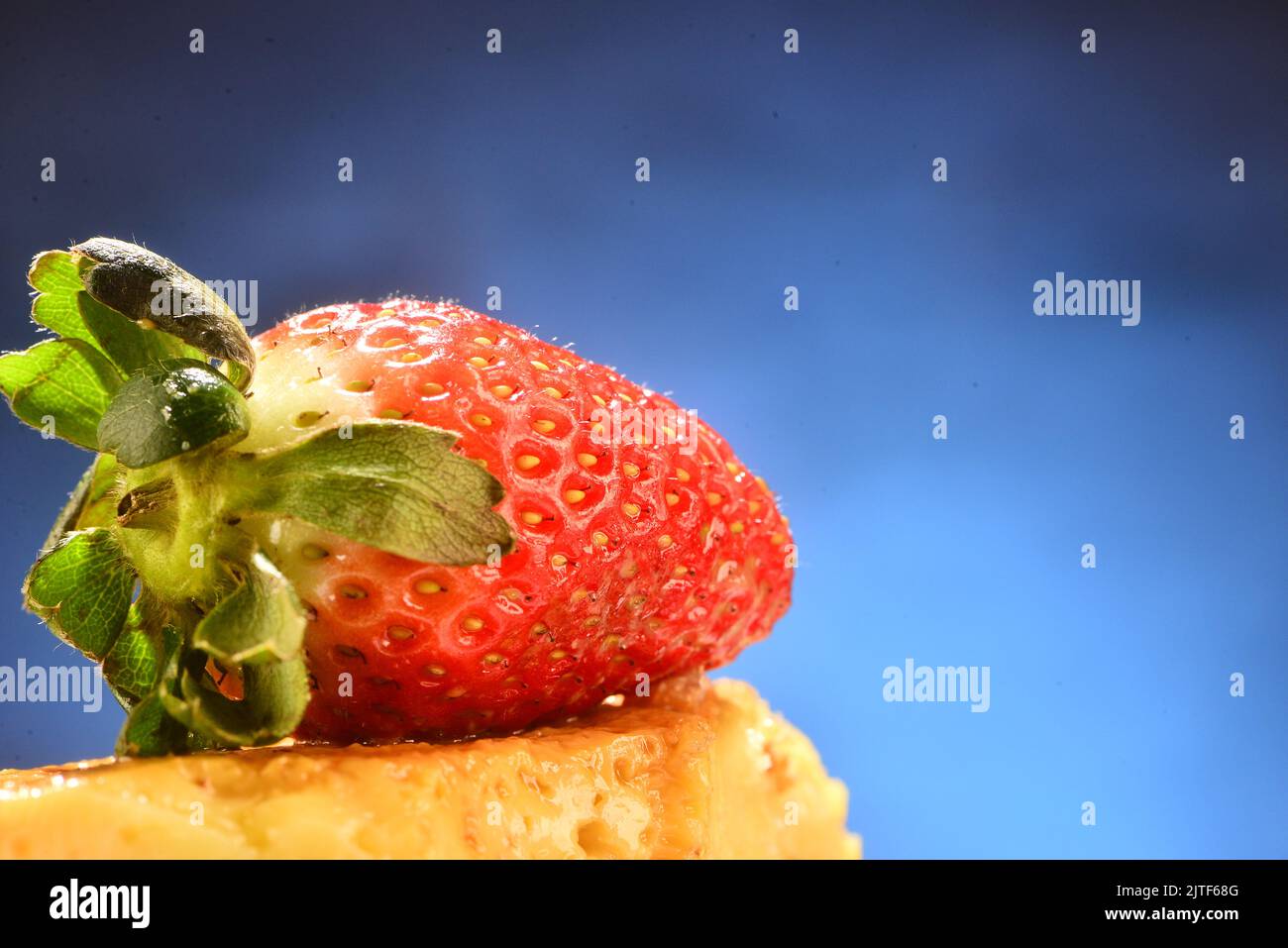 Strawberry fruit on blue hi-res stock photography and images - Alamy