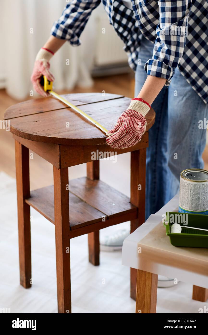 woman with ruler measuring table for renovation Stock Photo - Alamy