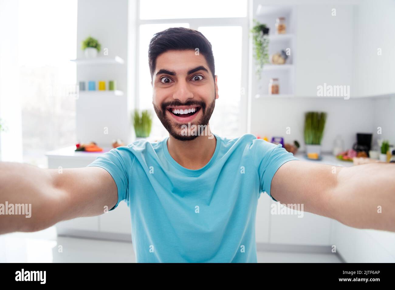 Portrait of satisfied glad young man make selfie recording video toothy ...