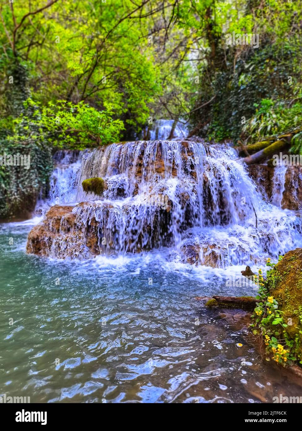 A beautiful rocky waterfall flowing downstream in a forest Stock Photo ... A beautiful rocky waterfall flowing downstream in a forest Stock Photo ...