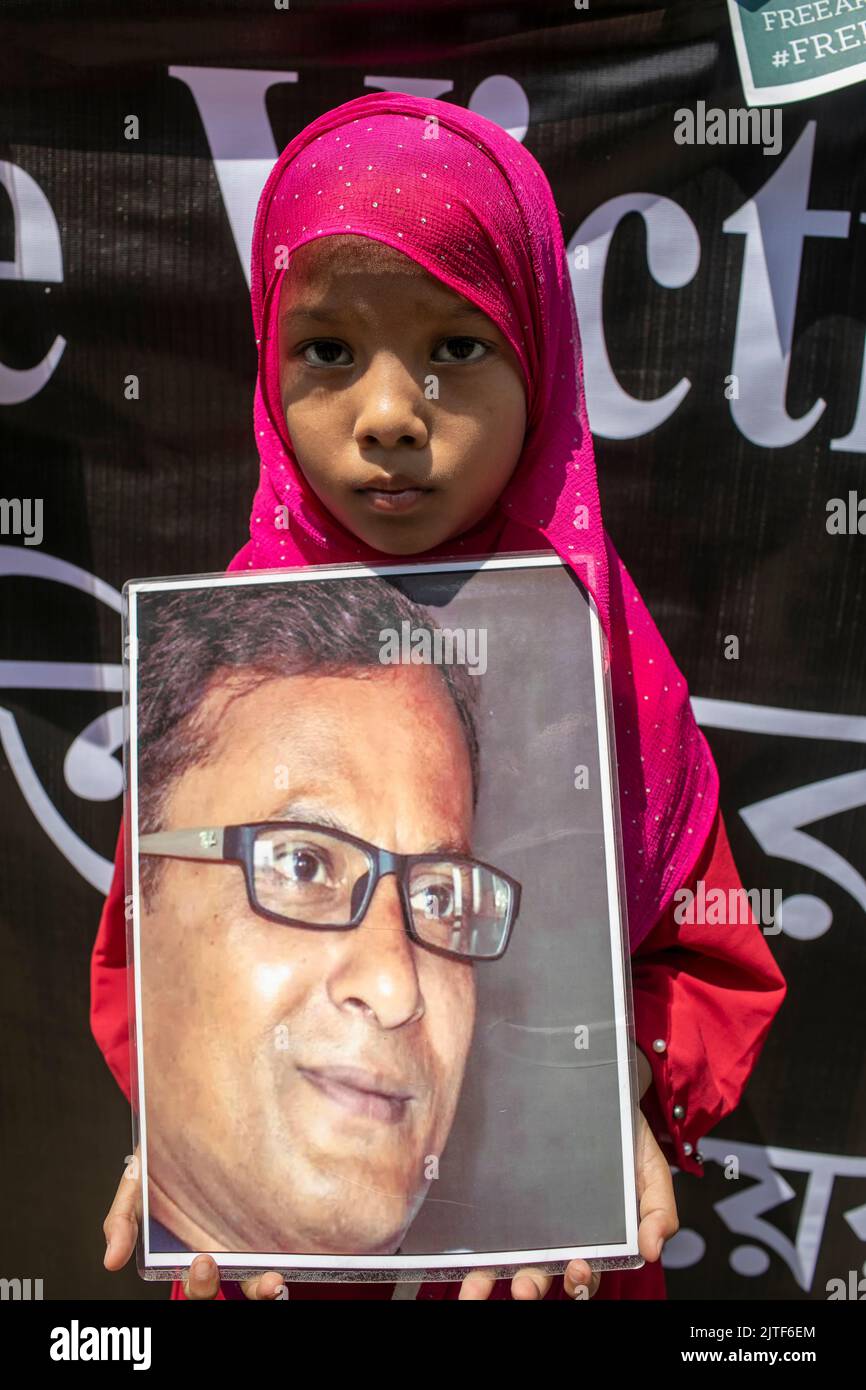 Dhaka, Bangladesh - 30 Aug 2022, A kid holds a picture of her missing father during the ...