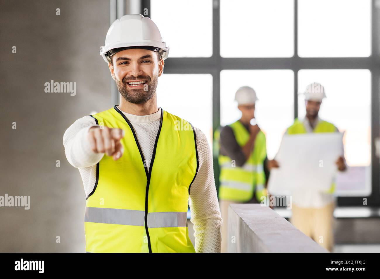 male architect in helmet and safety west at office Stock Photo - Alamy