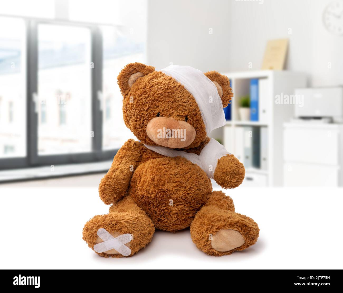 teddy bear with bandaged head and paw at clinic Stock Photo - Alamy