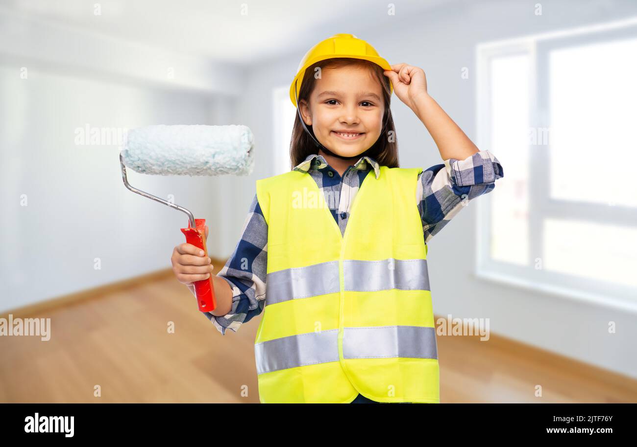 girl in helmet and safety vest with paint roller Stock Photo - Alamy