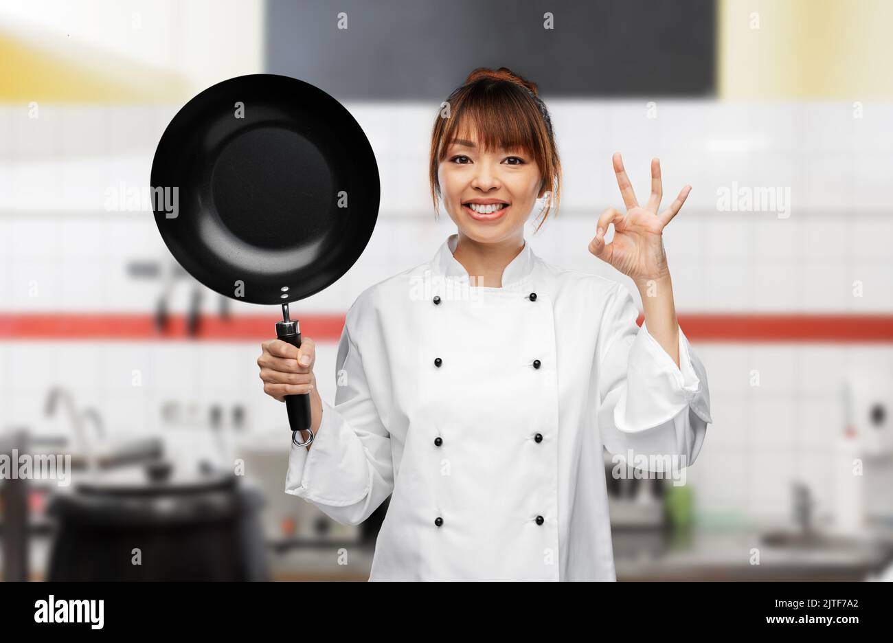 happy female chef with frying pan showing ok sign Stock Photo - Alamy