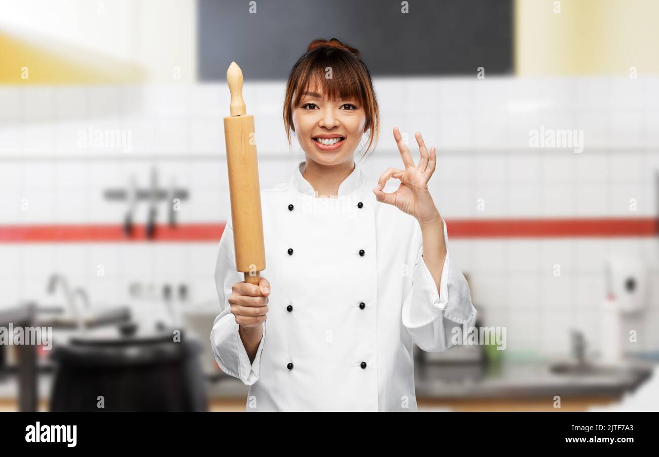 female chef or baker with rolling pin showing ok Stock Photo - Alamy