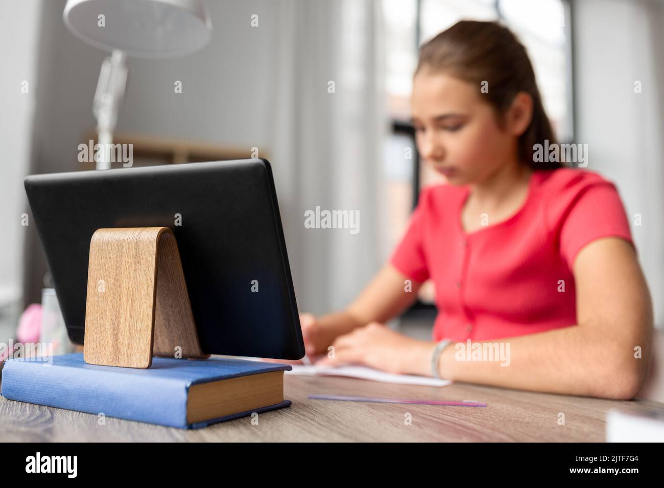 tablet pc and student girl learning at home Stock Photo - Alamy