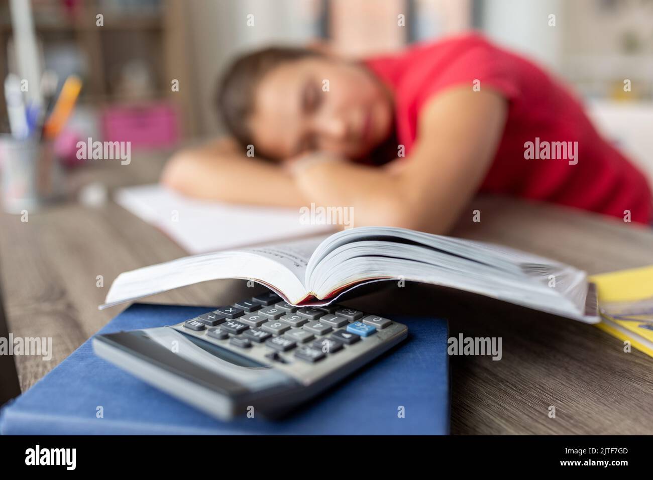 book, calculator and student sleeping on table Stock Photo - Alamy