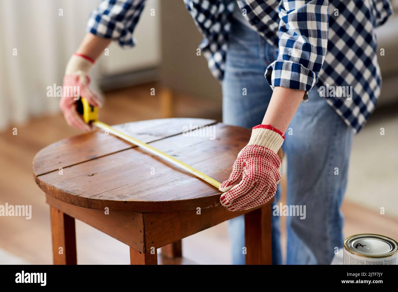woman with ruler measuring table for renovation Stock Photo - Alamy