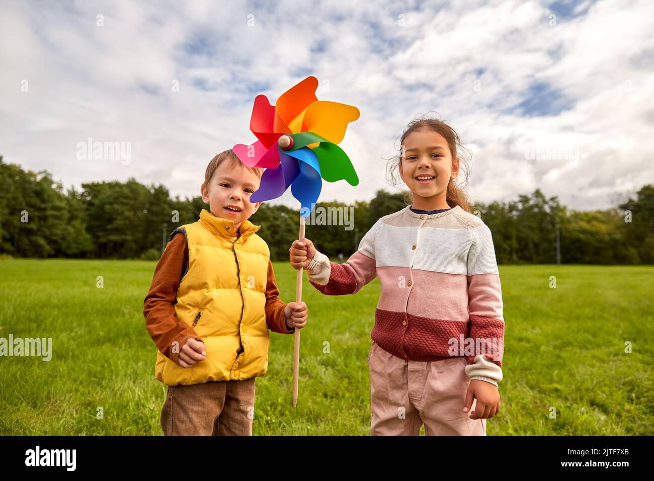 happy children playing with pinwheel at park Stock Photo - Alamy