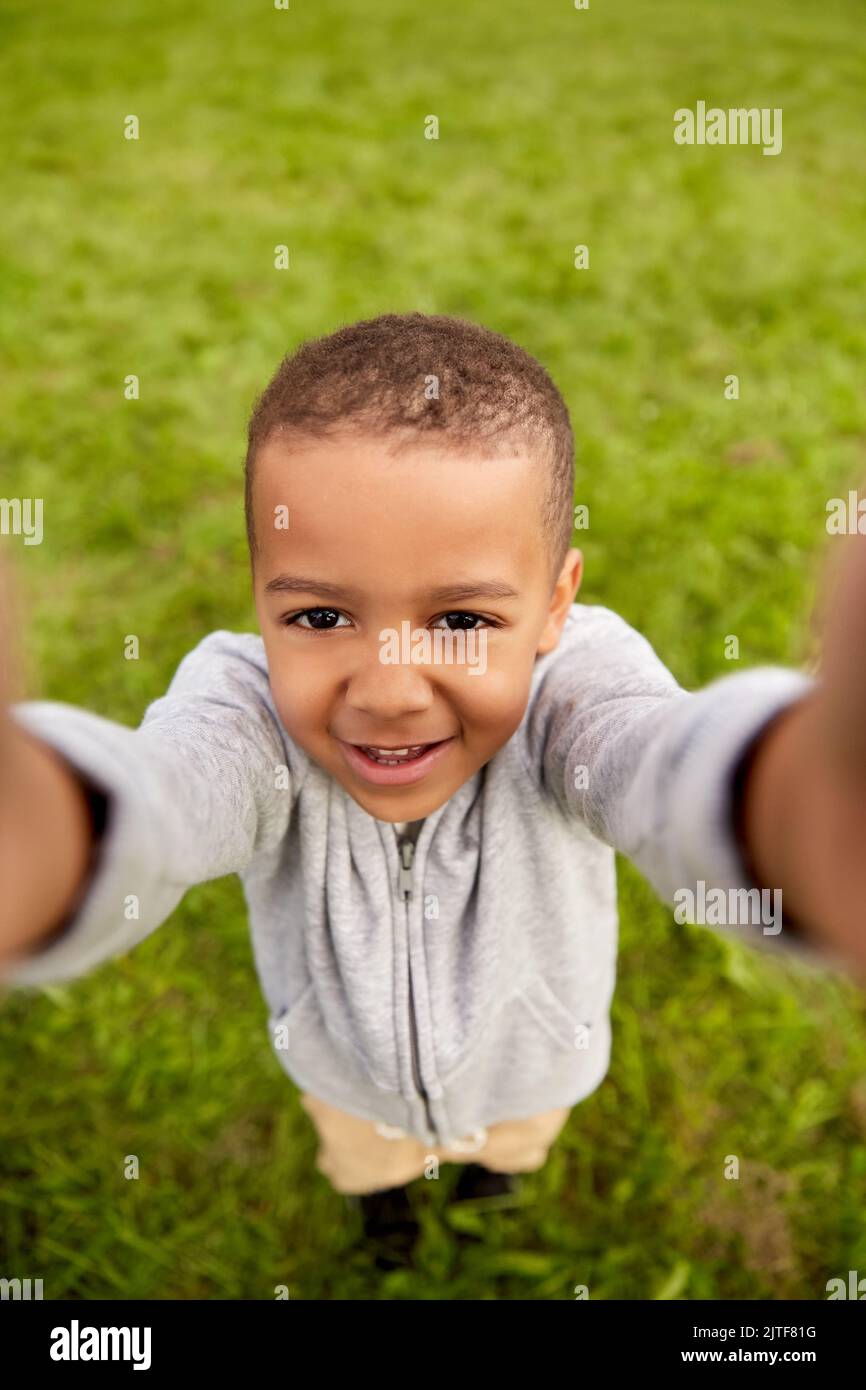 happy smiling little boy taking selfie at park Stock Photo - Alamy