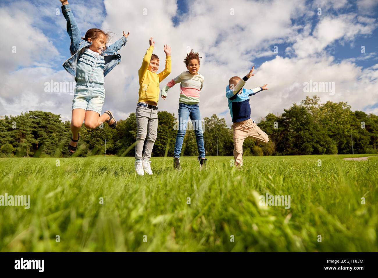 happy children jumping at park Stock Photo - Alamy