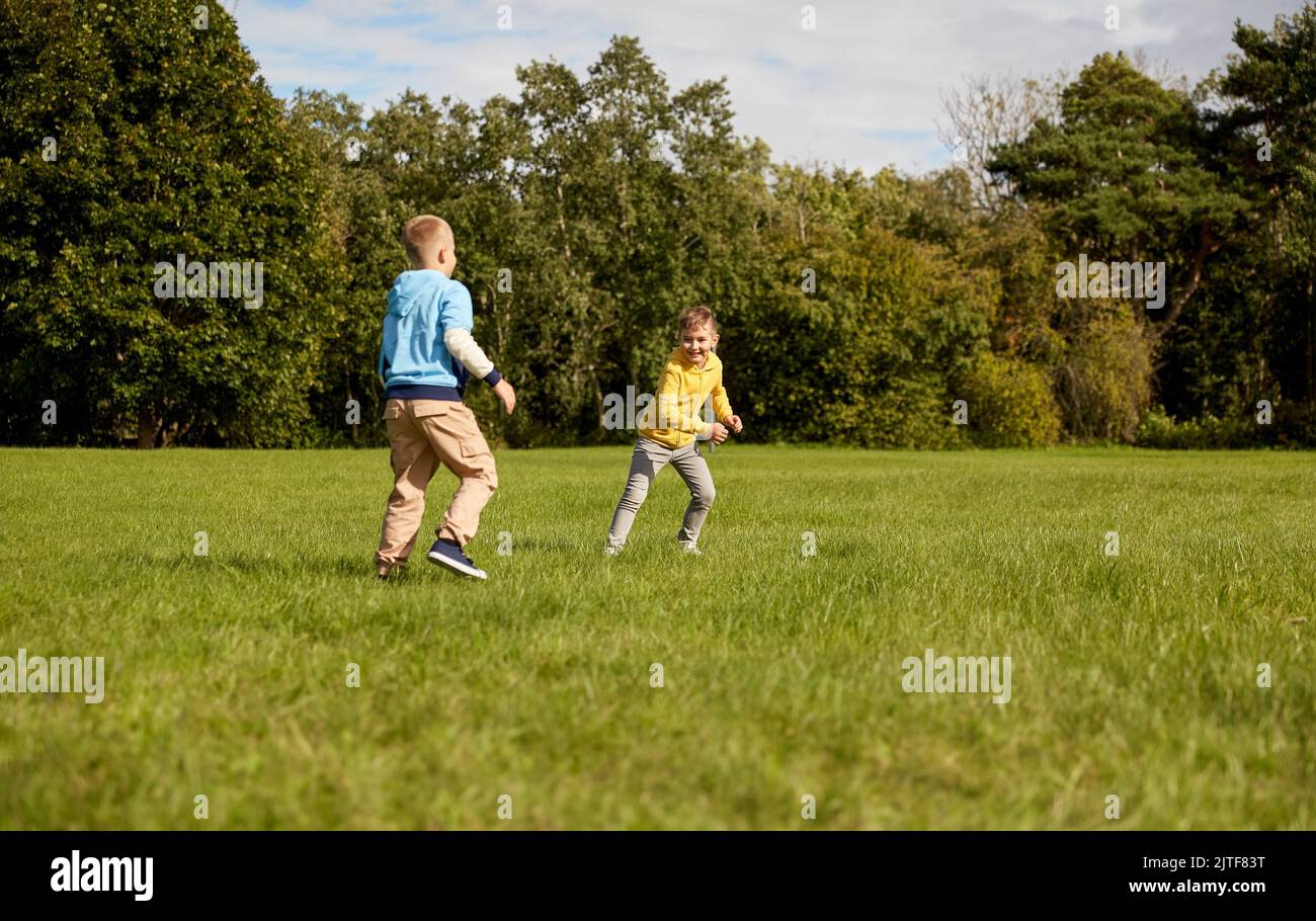 happy boys playing and running at park Stock Photo - Alamy