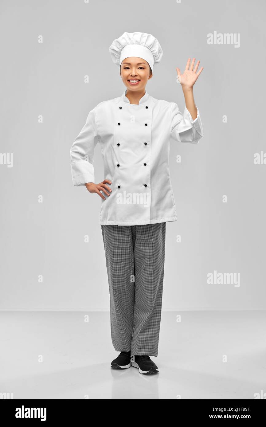 smiling female chef waving hand Stock Photo - Alamy
