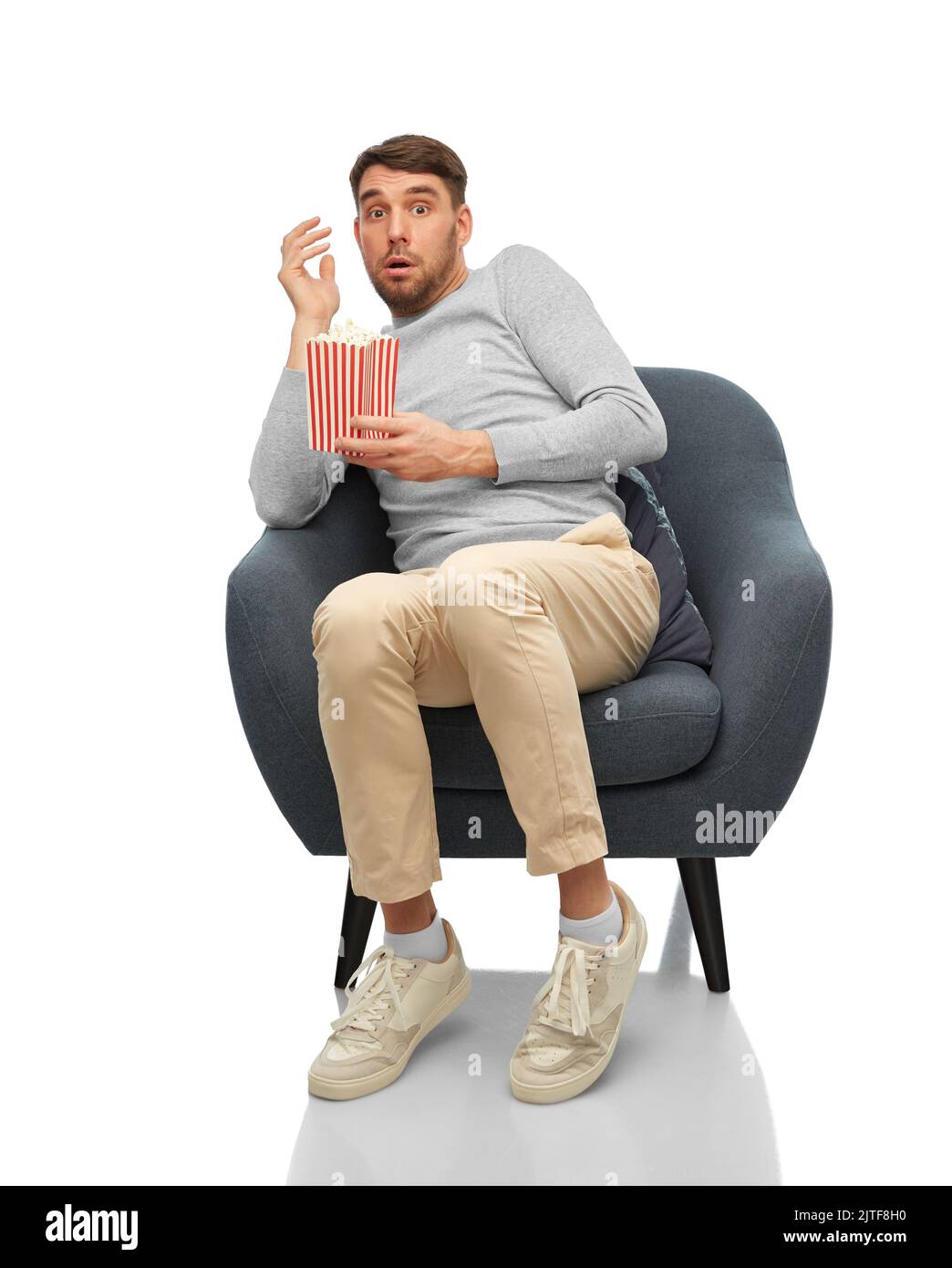 scared man with popcorn sitting in chair Stock Photo - Alamy