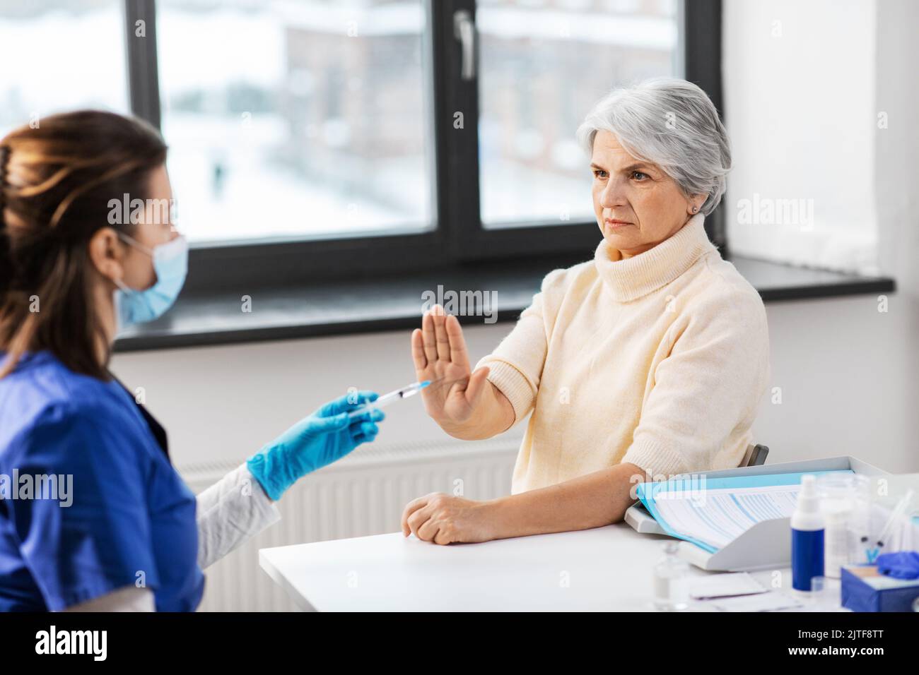 nurse with syringe and woman refusing from vaccine Stock Photo - Alamy