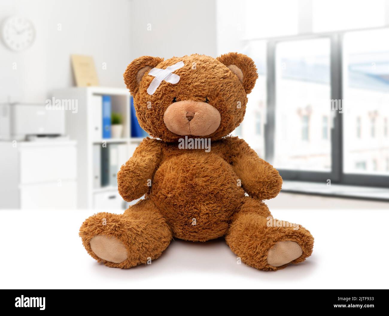 teddy bear toy with medical patch on head Stock Photo - Alamy