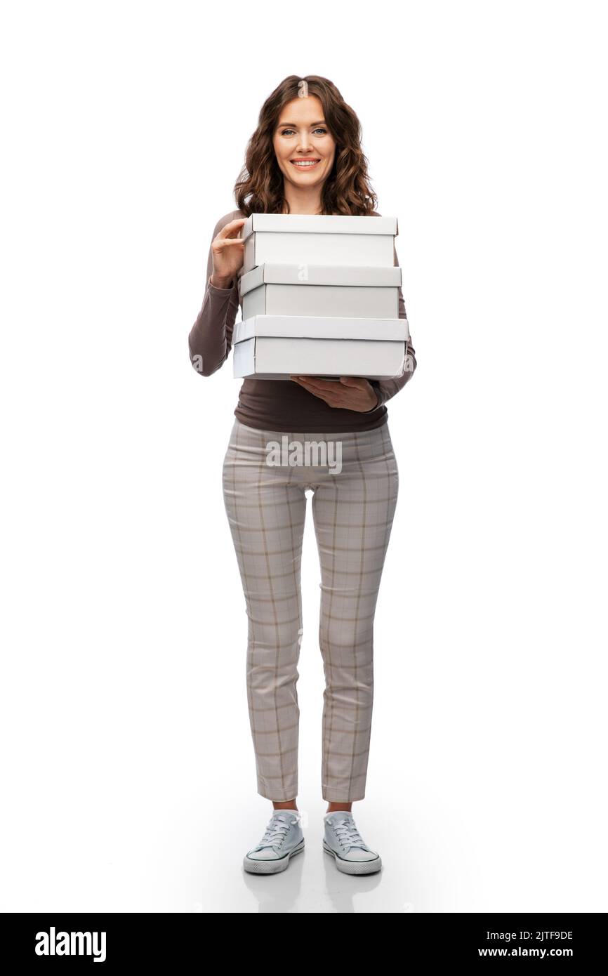 Young female shop assistant holding shoe boxes hi-res stock photography ...