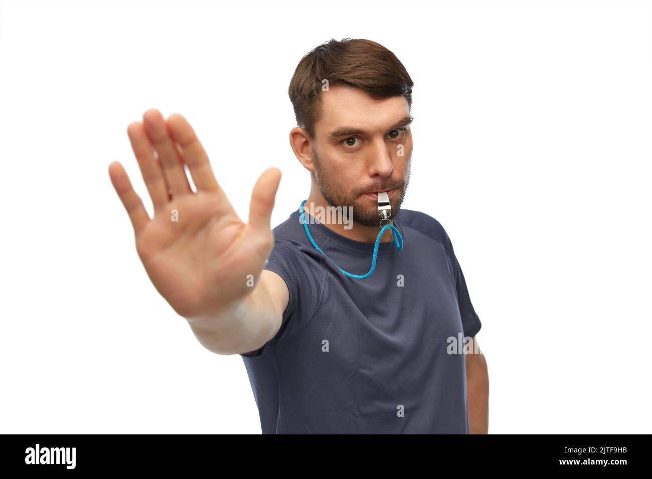 trainer or referee with whistle showing stop gesture Stock Photo - Alamy