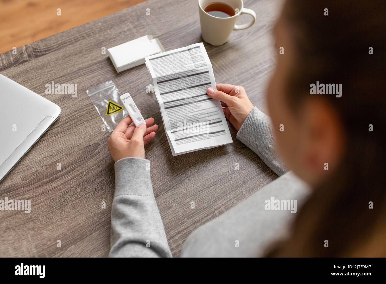woman reading coronavirus test manual at home Stock Photo - Alamy