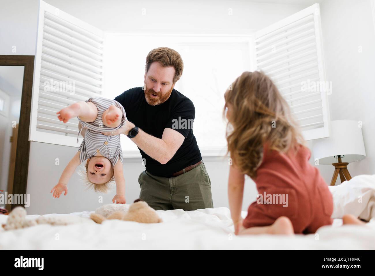 Father holding baby upside down hi-res stock photography and images - Alamy