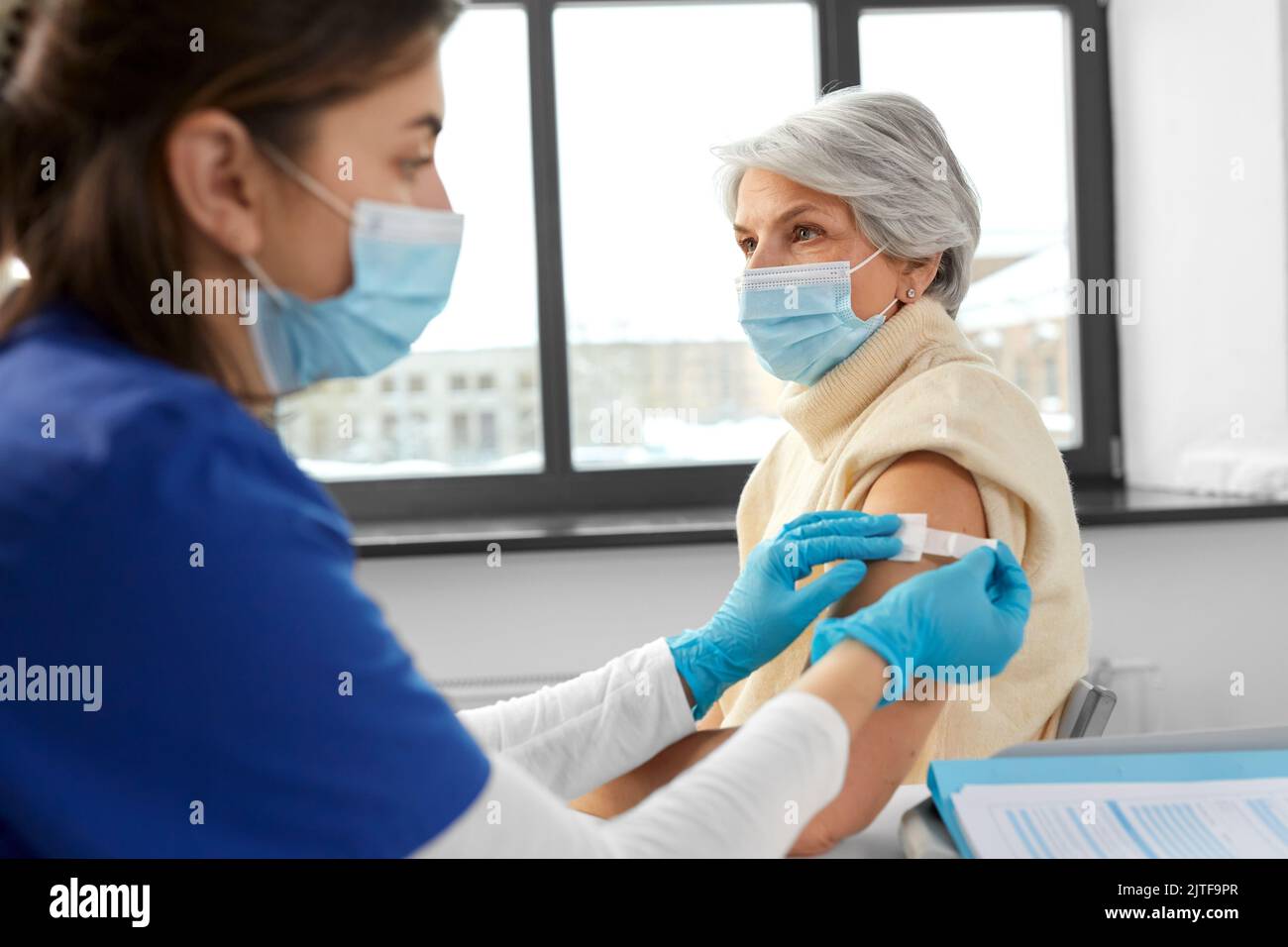 Nurse putting band aid hi-res stock photography and images - Alamy