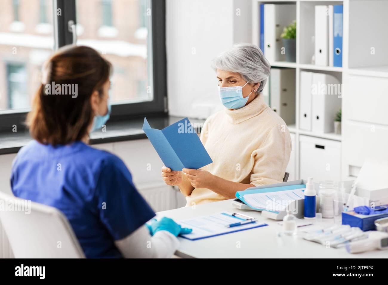 doctor and senior woman reading medical brochure Stock Photo - Alamy