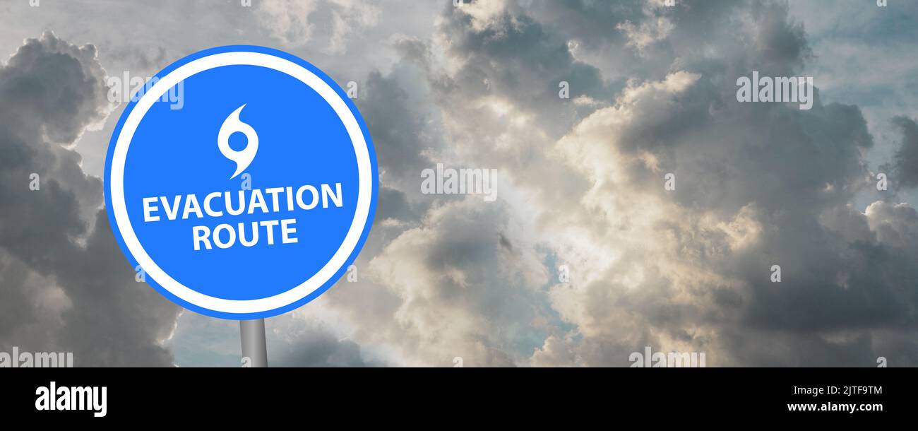 evacuation route sign on cloudy sky background Stock Photo - Alamy