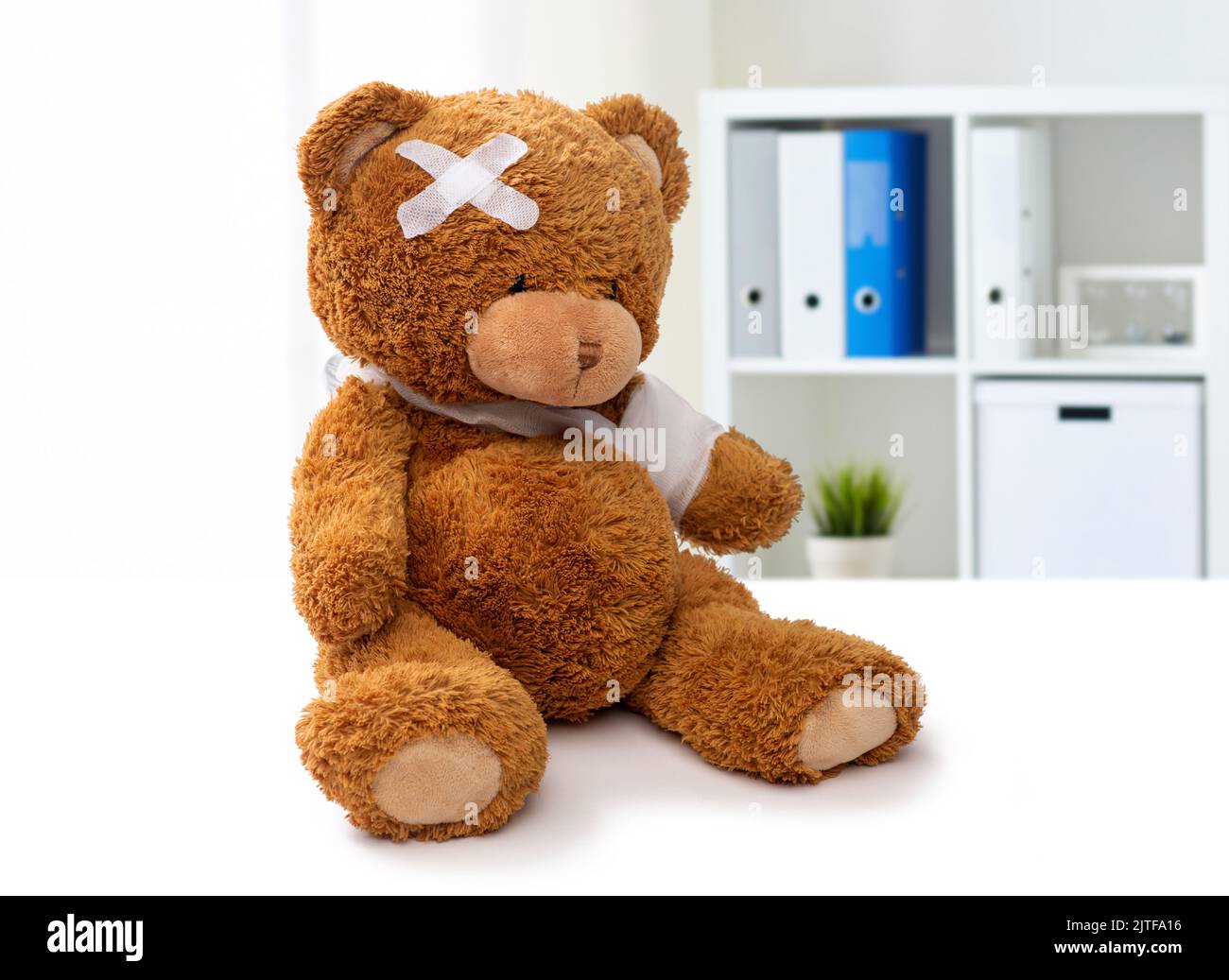 teddy bear toy with bandaged paw and patch on head Stock Photo - Alamy