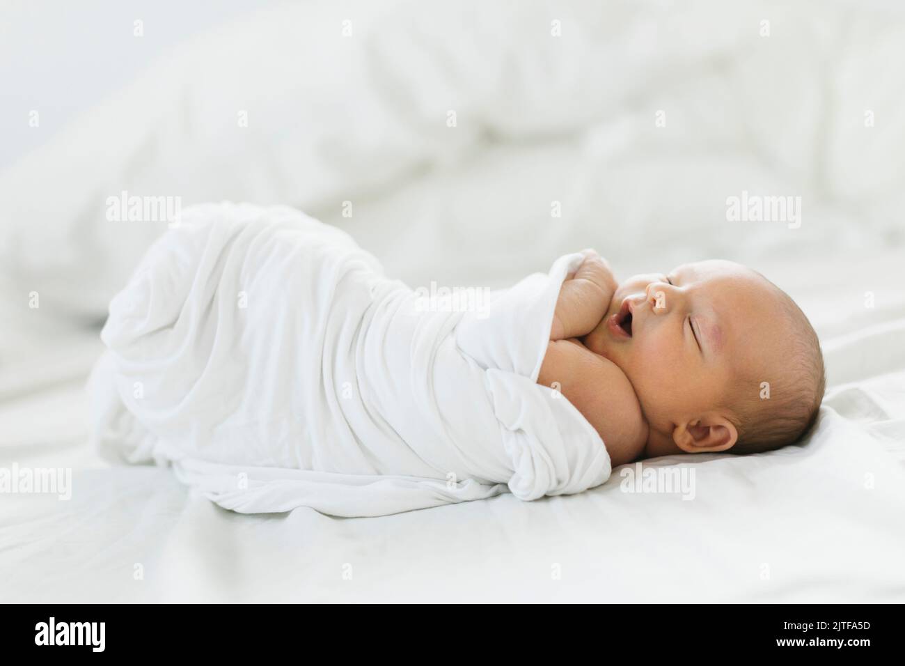 Newborn swaddled hi-res stock photography and images - Alamy