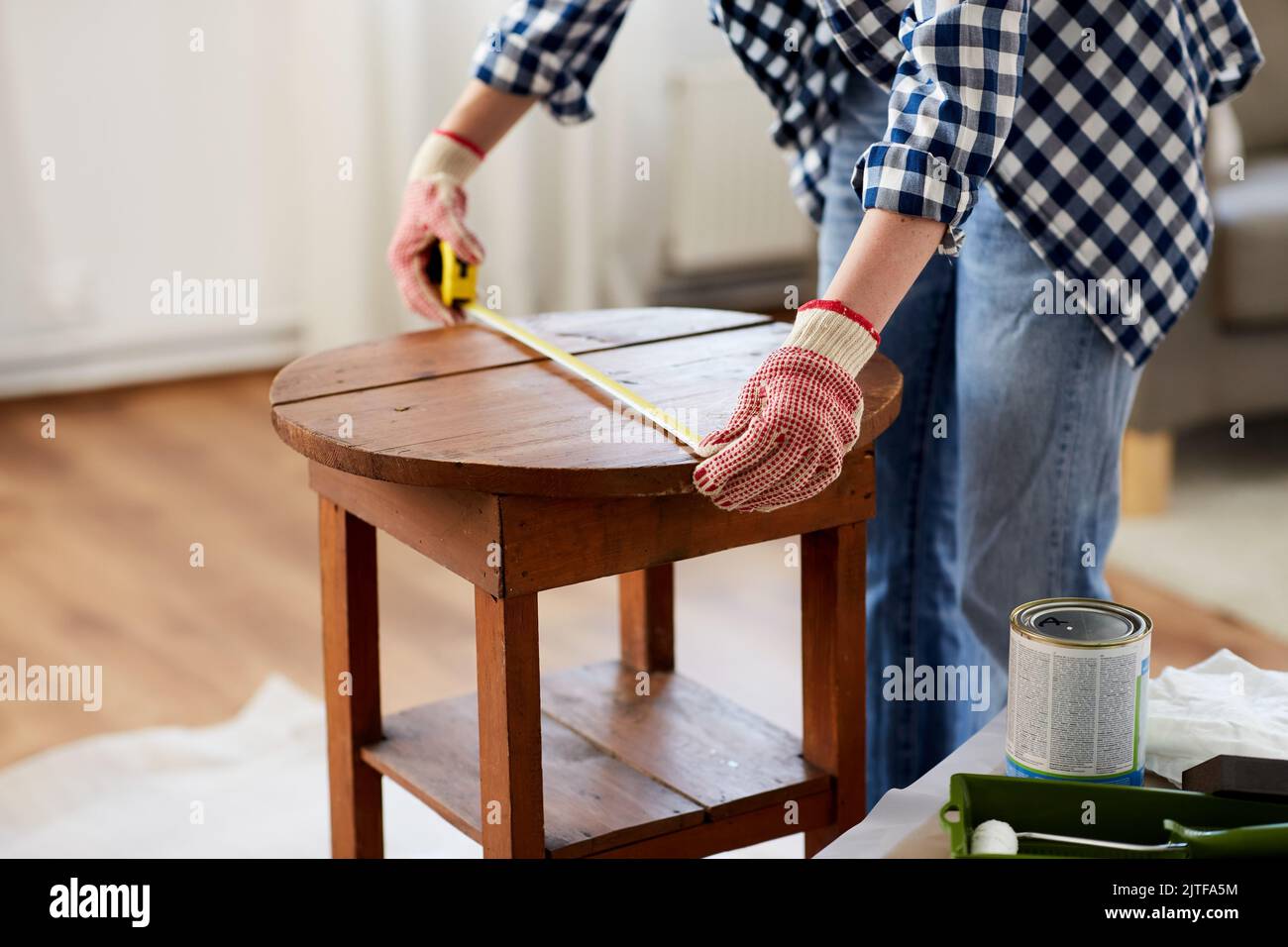 woman with ruler measuring table for renovation Stock Photo - Alamy