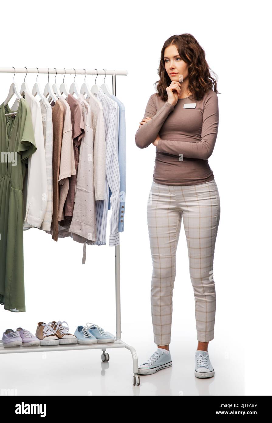 female shop assistant with clothes on hanger Stock Photo - Alamy