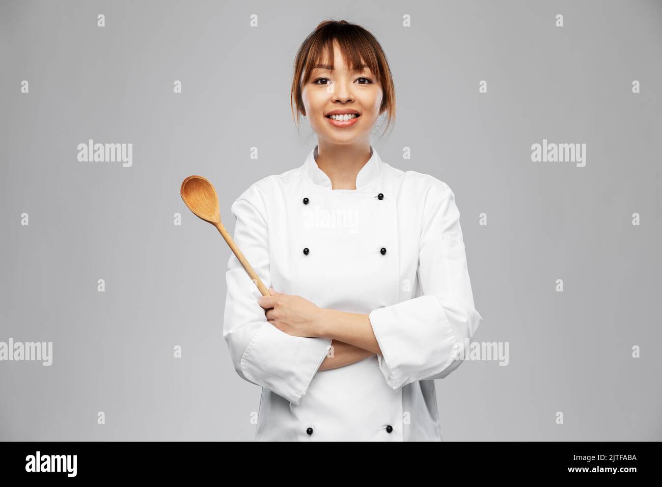 happy smiling female chef with wooden spoon Stock Photo - Alamy