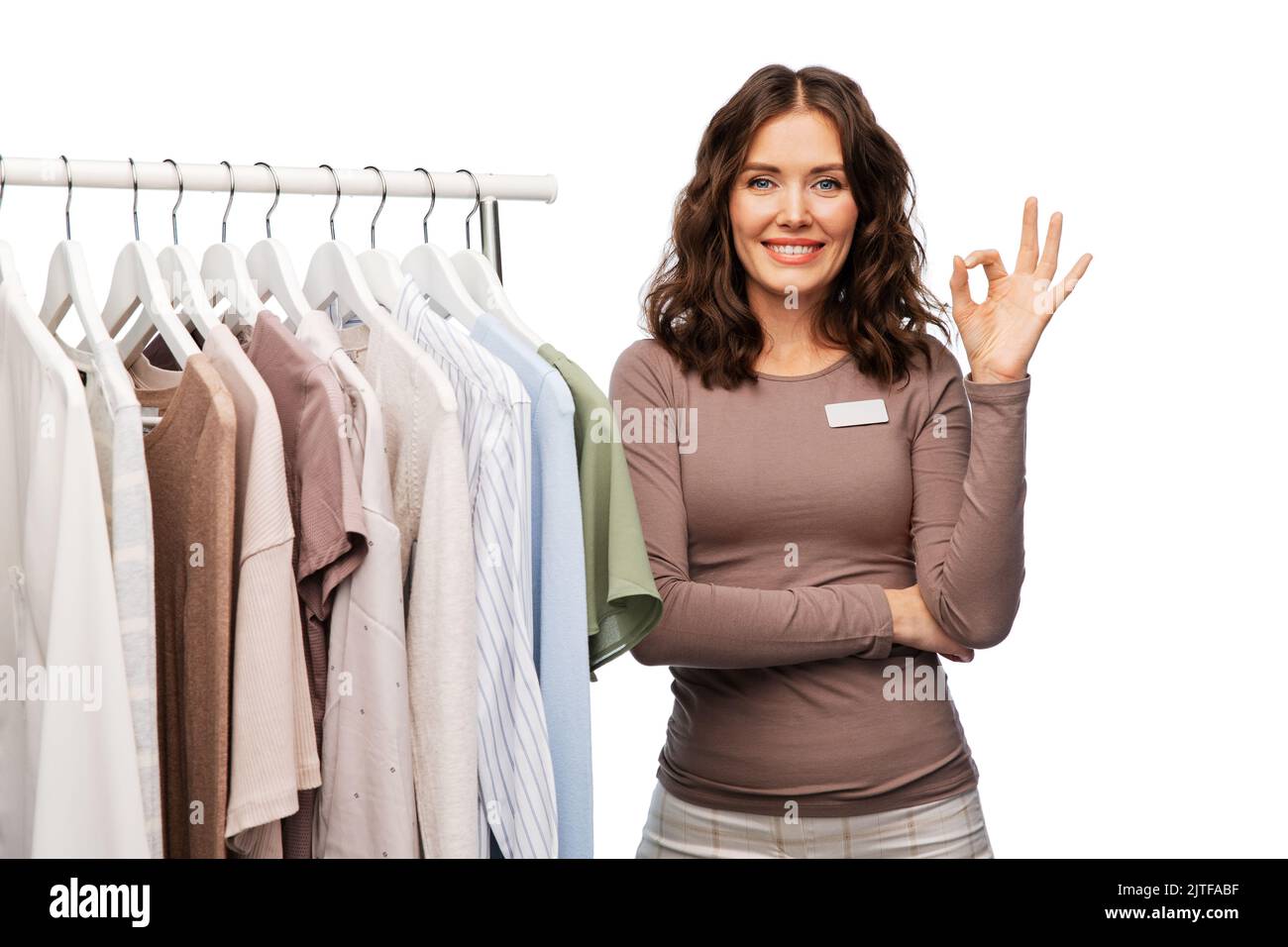 happy female shop assistant with clothes on hanger Stock Photo - Alamy