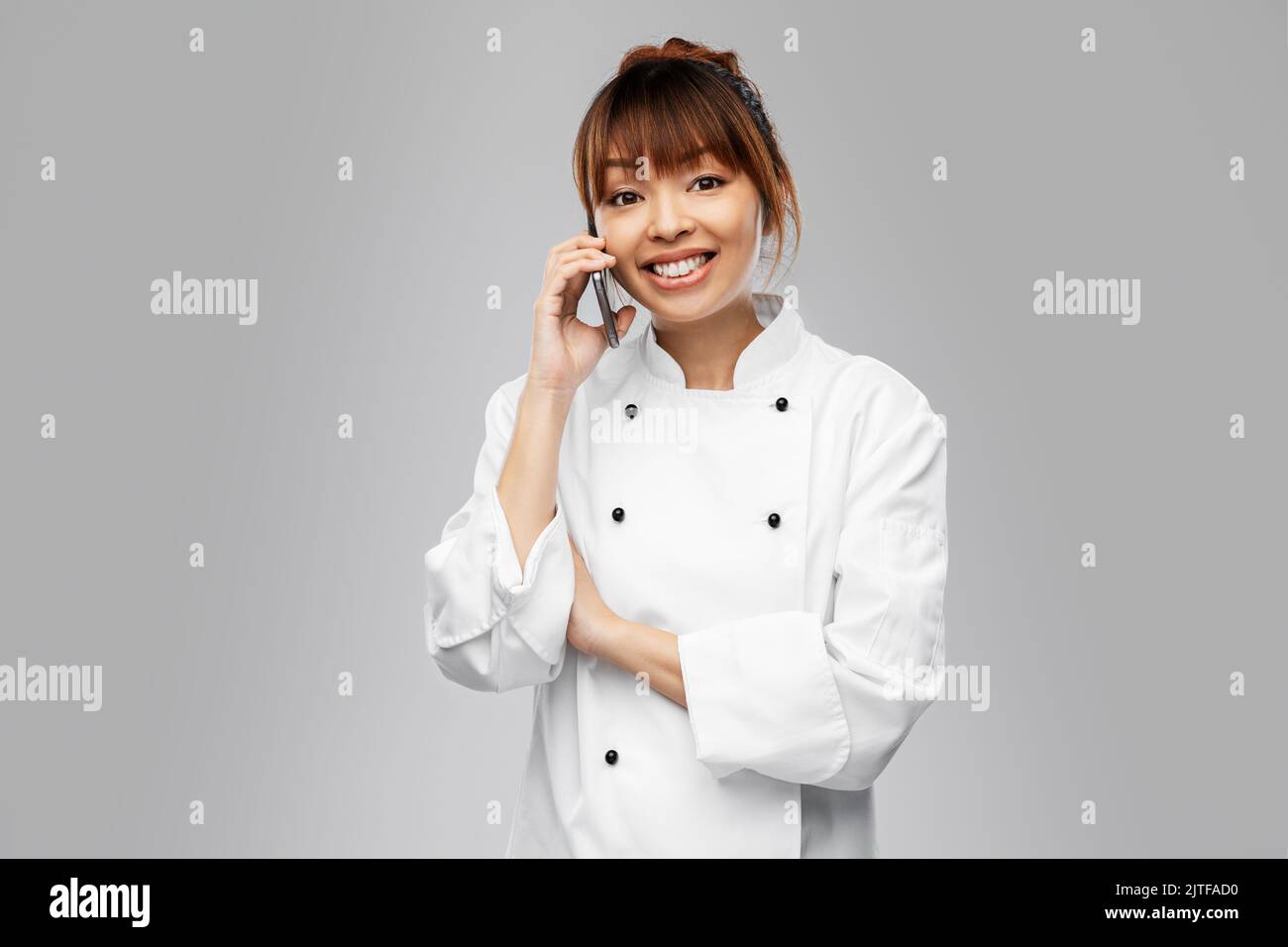 happy female chef calling on phone Stock Photo - Alamy