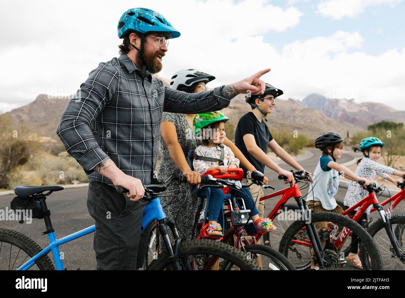 Family with children (2-3, 8-9, 14-15) biking together Stock Photo - Alamy