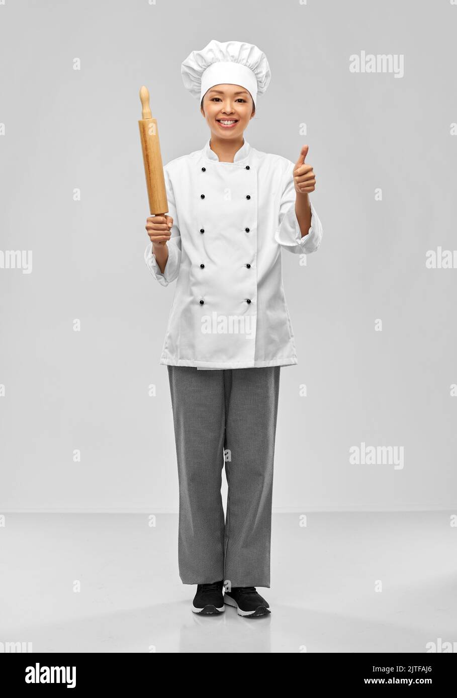 smiling female chef or baker with rolling pin Stock Photo - Alamy