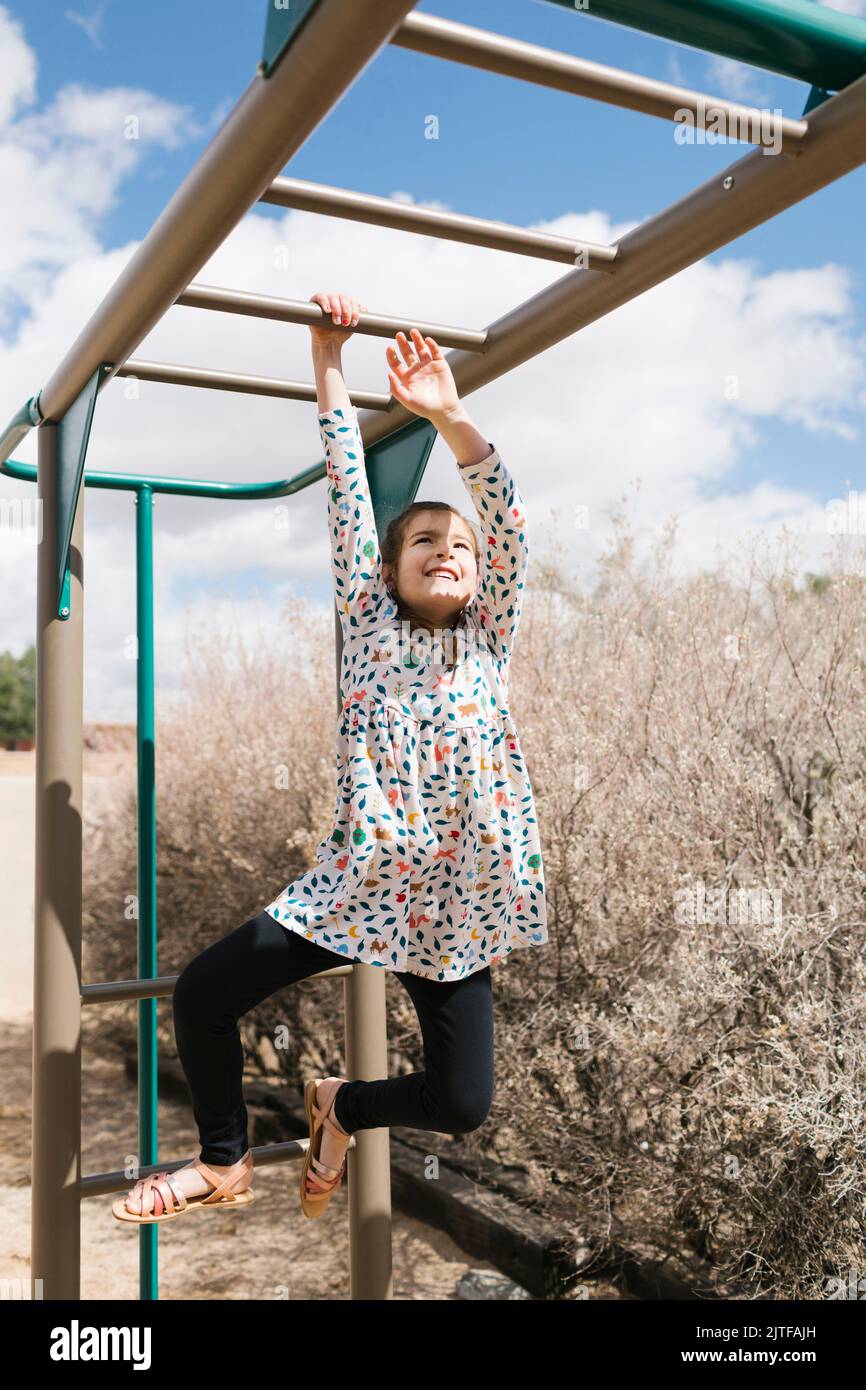 Girl on playground monkey bars hi-res stock photography and images - Alamy