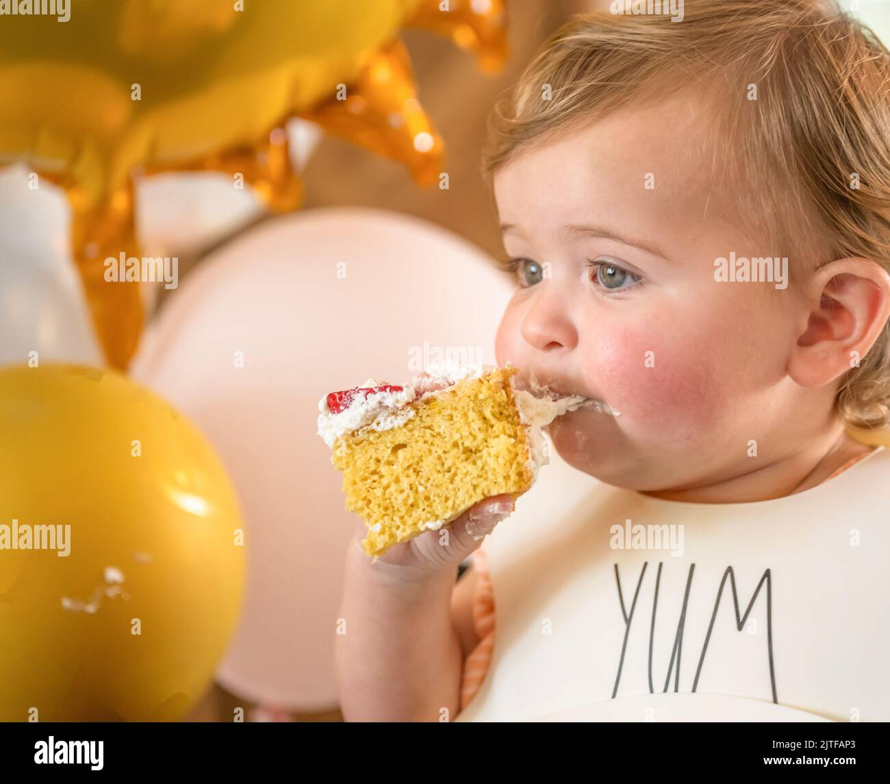 Baby girl (12-17 months) eating birthday cake Stock Photo - Alamy