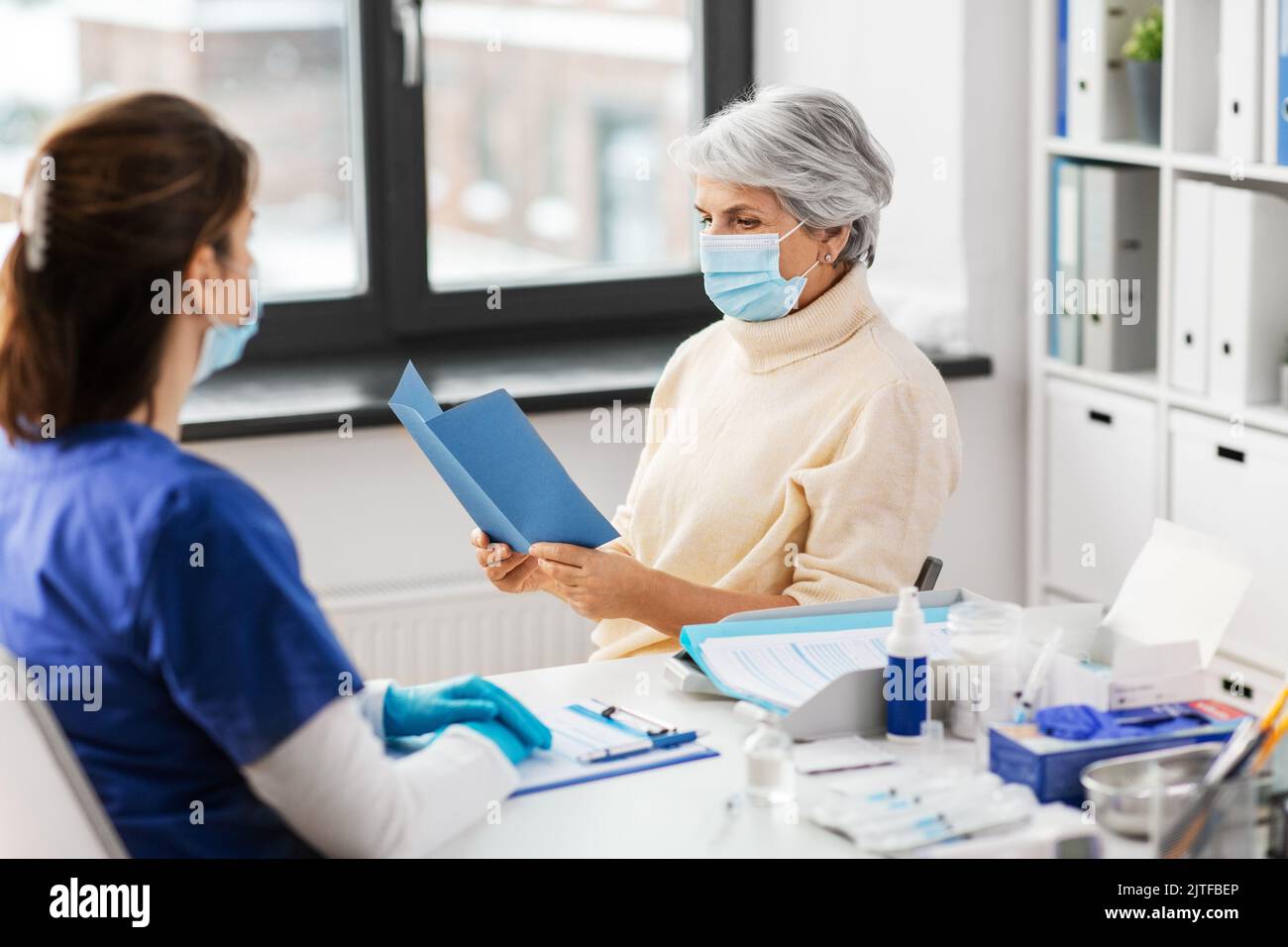 Doctor senior patient booklet hi-res stock photography and images - Alamy
