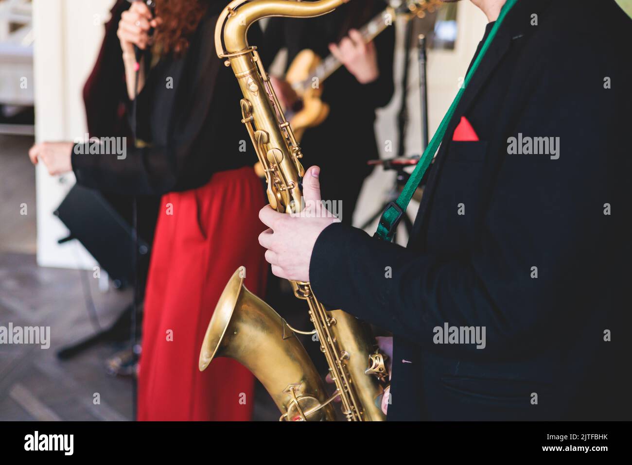 Concert view of saxophonist, a saxophone sax player with vocalist and ...
