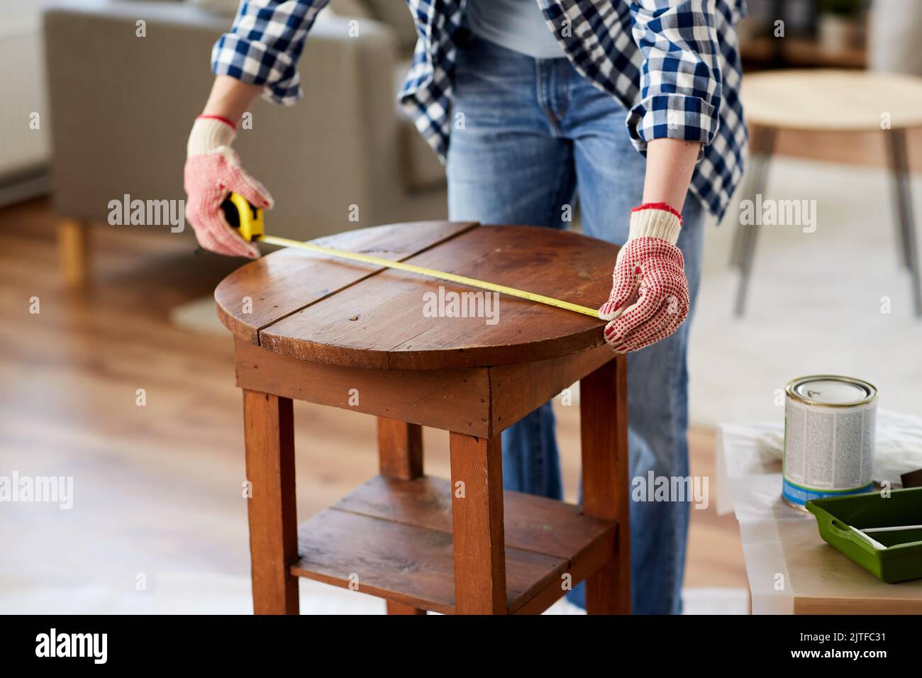 woman with ruler measuring table for renovation Stock Photo - Alamy
