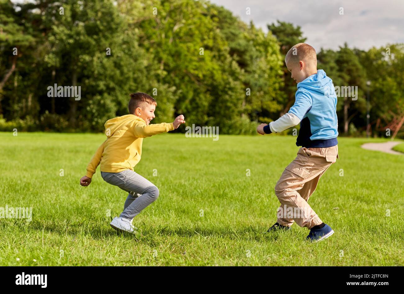 two happy boys playing tag game at park Stock Photo - Alamy