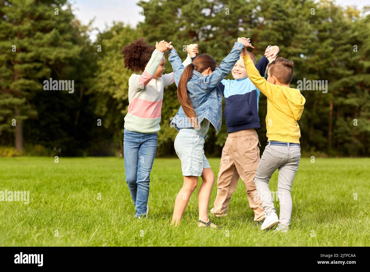 happy children playing round dance at park Stock Photo - Alamy