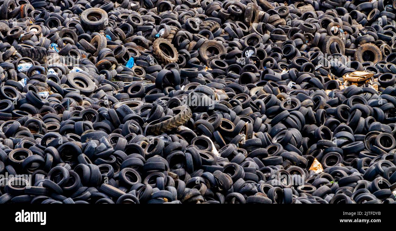 Backdrop of landfill with old used tires Stock Photo - Alamy